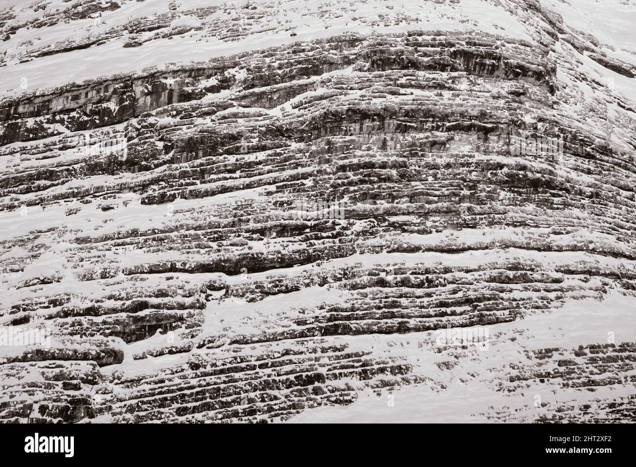 Huge cliff fully covered in snow in the daytime Stock Photo - Alamy