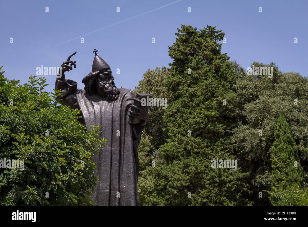 View of a big sculpture statue of Gregory of Nin among green trees in ...