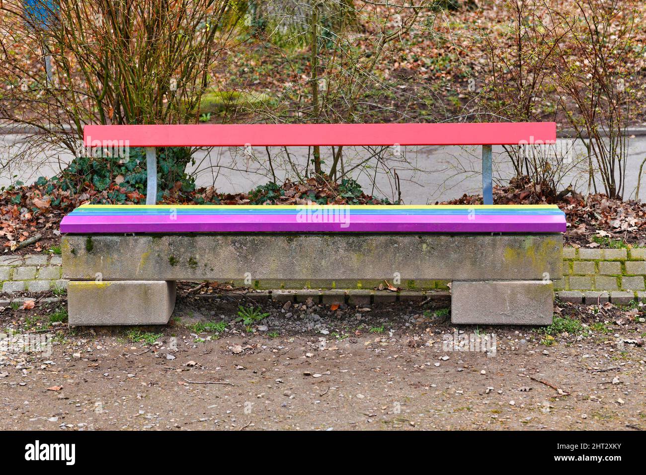 Park bench painted with bright rainbow colors Stock Photo - Alamy