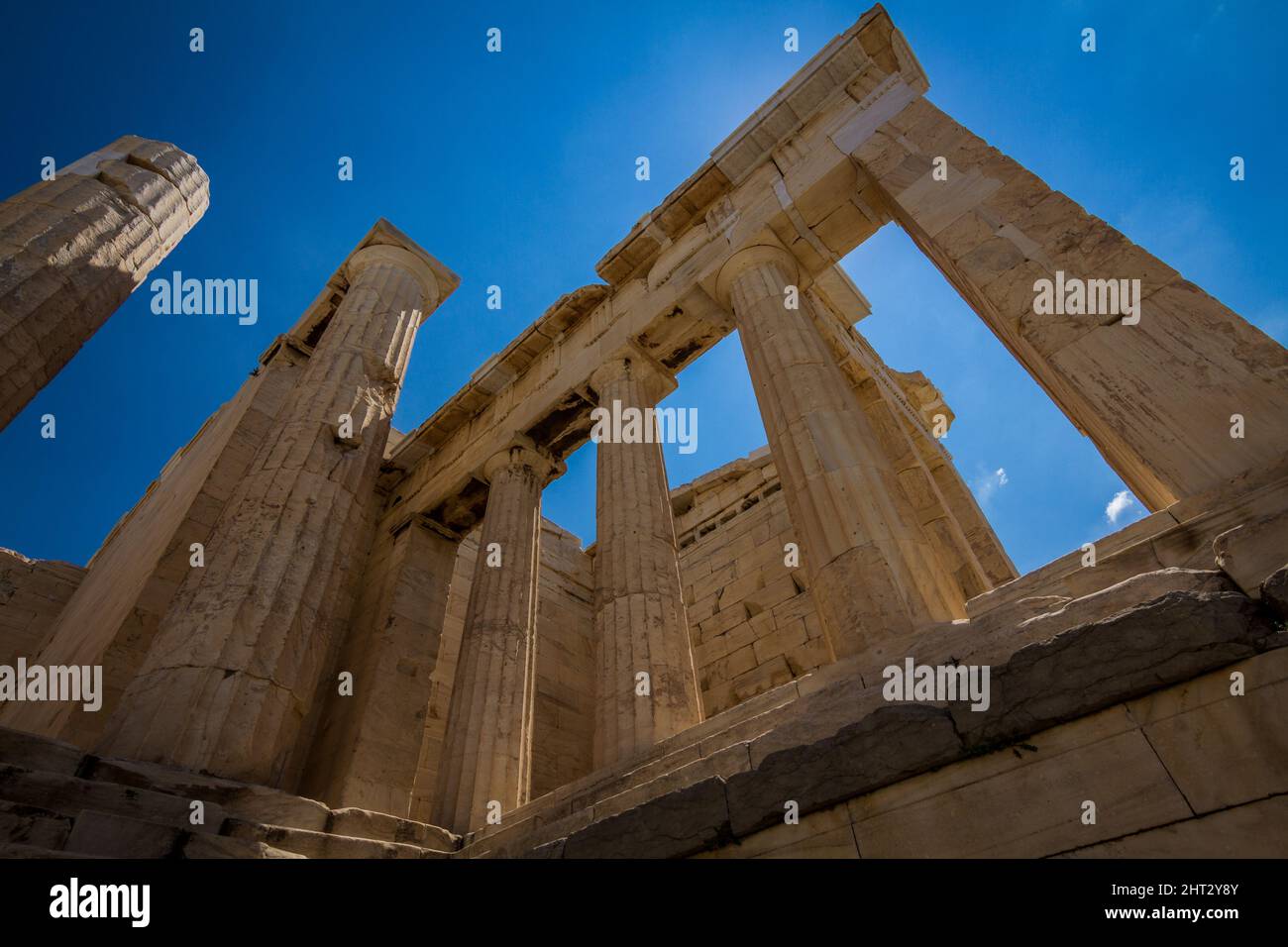 Low angle view of stone marble columns of Acropolis of Athens ...