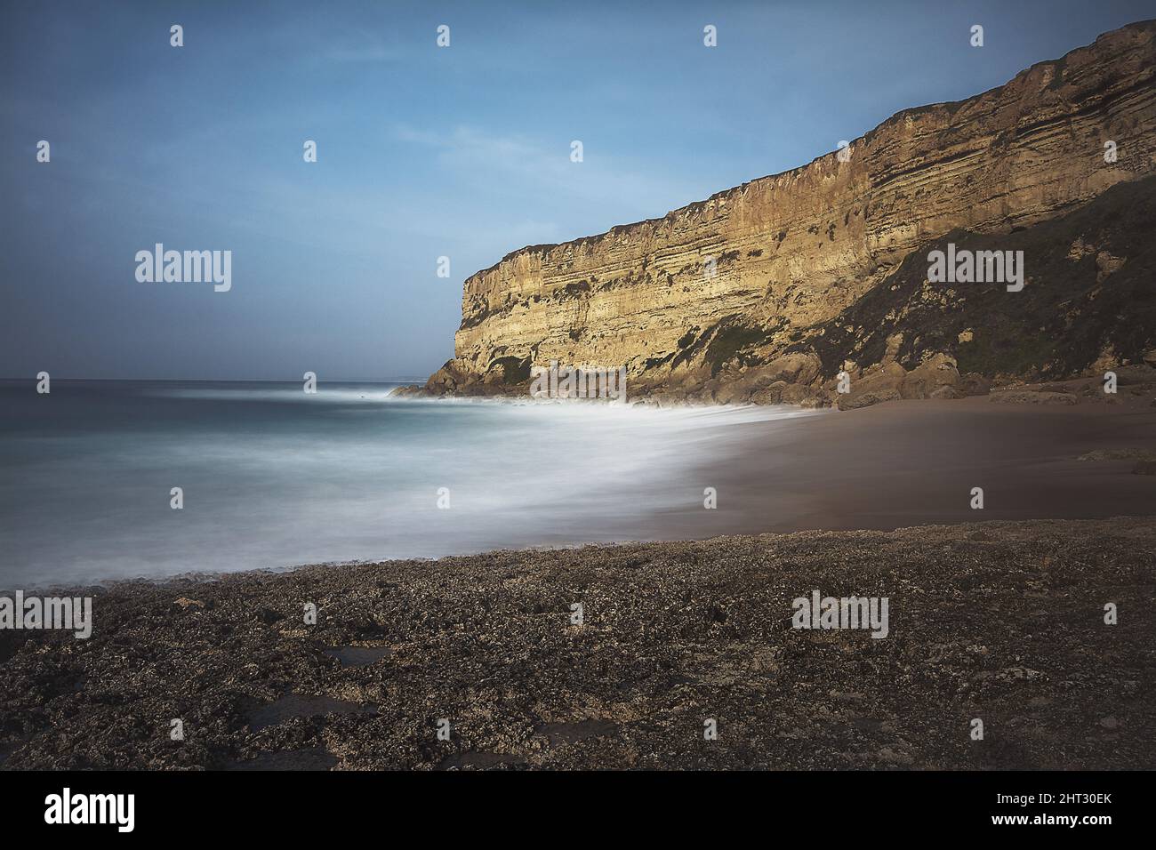 Wavy beach surrounded by rocks, Lisbon, Portugal Stock Photo - Alamy