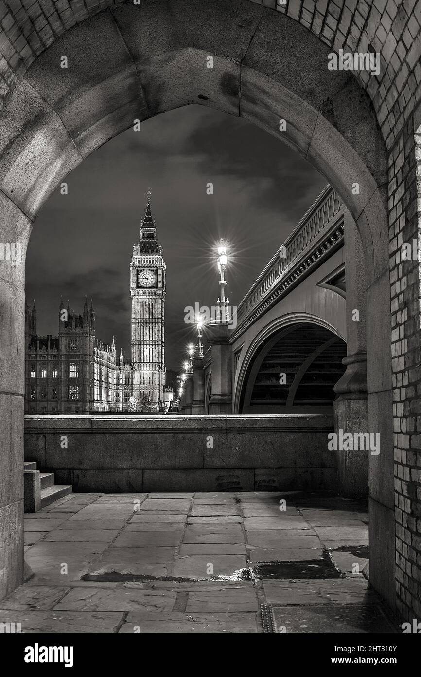 Vertical, grayscale shot of Big Ben clock tower from an arch, London ...