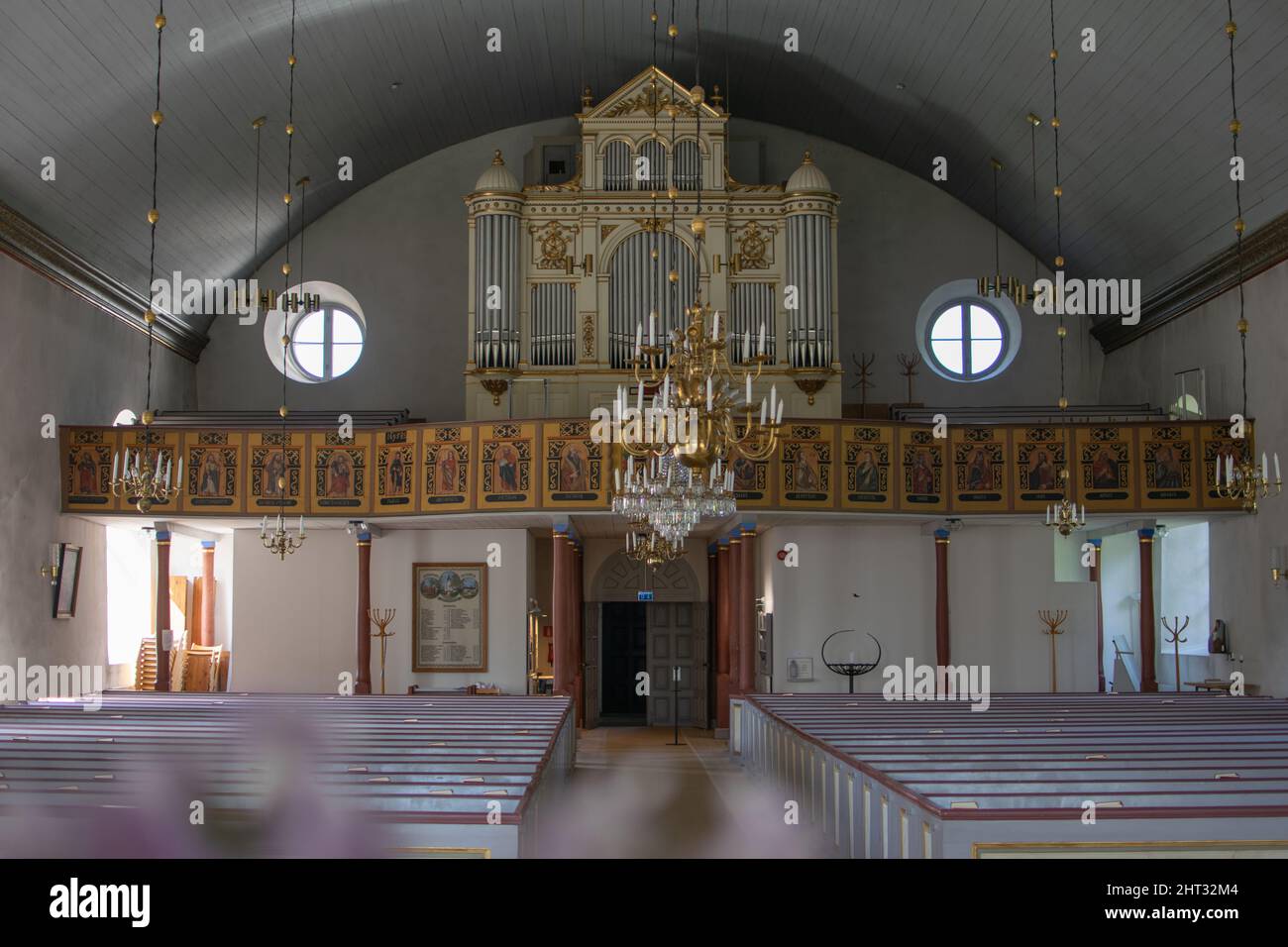 View of an empty church interior decorated holy icons and chandeliers ...