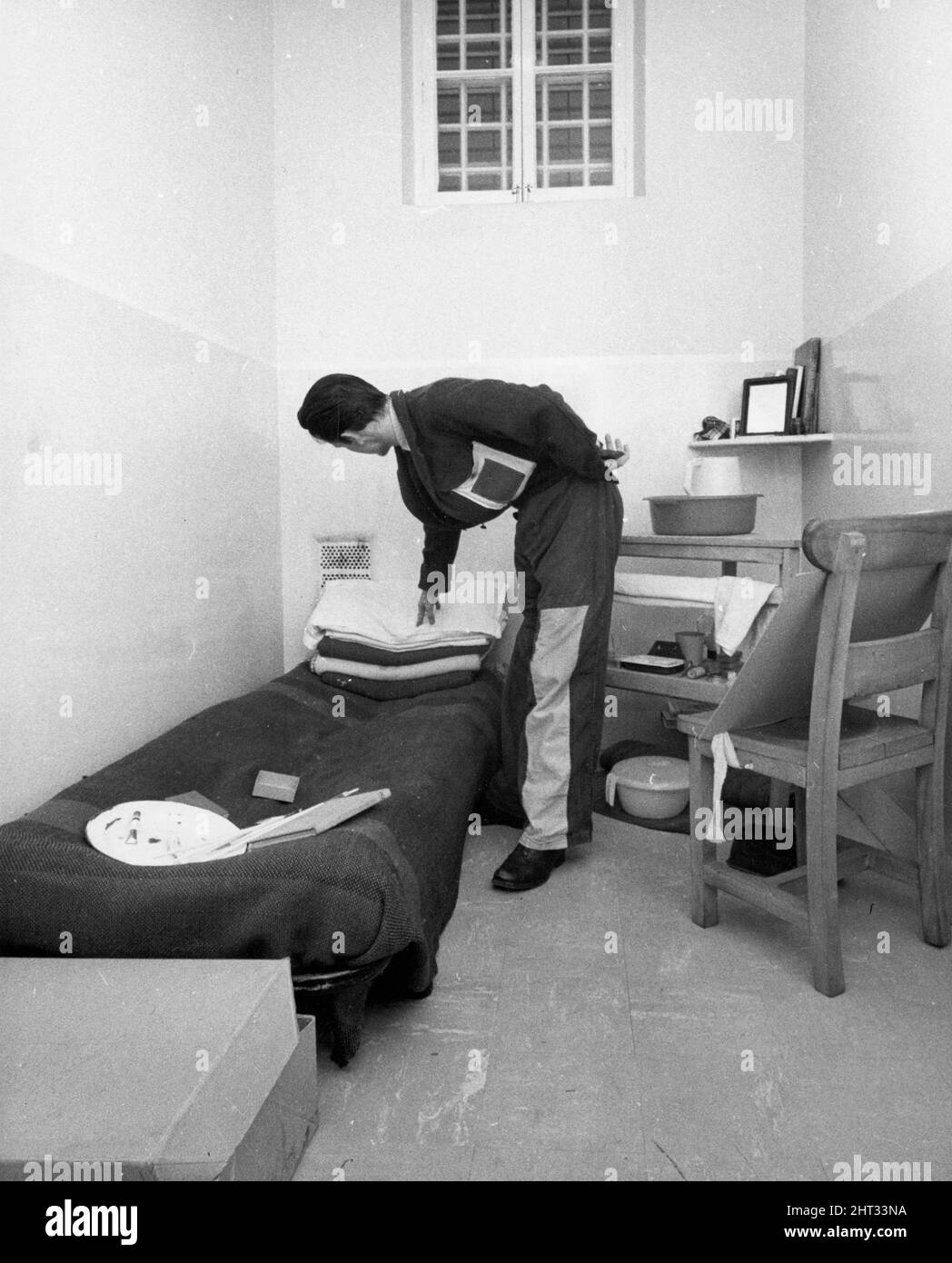 An interior view showing a prisoner by his bed in one of the cells at ...