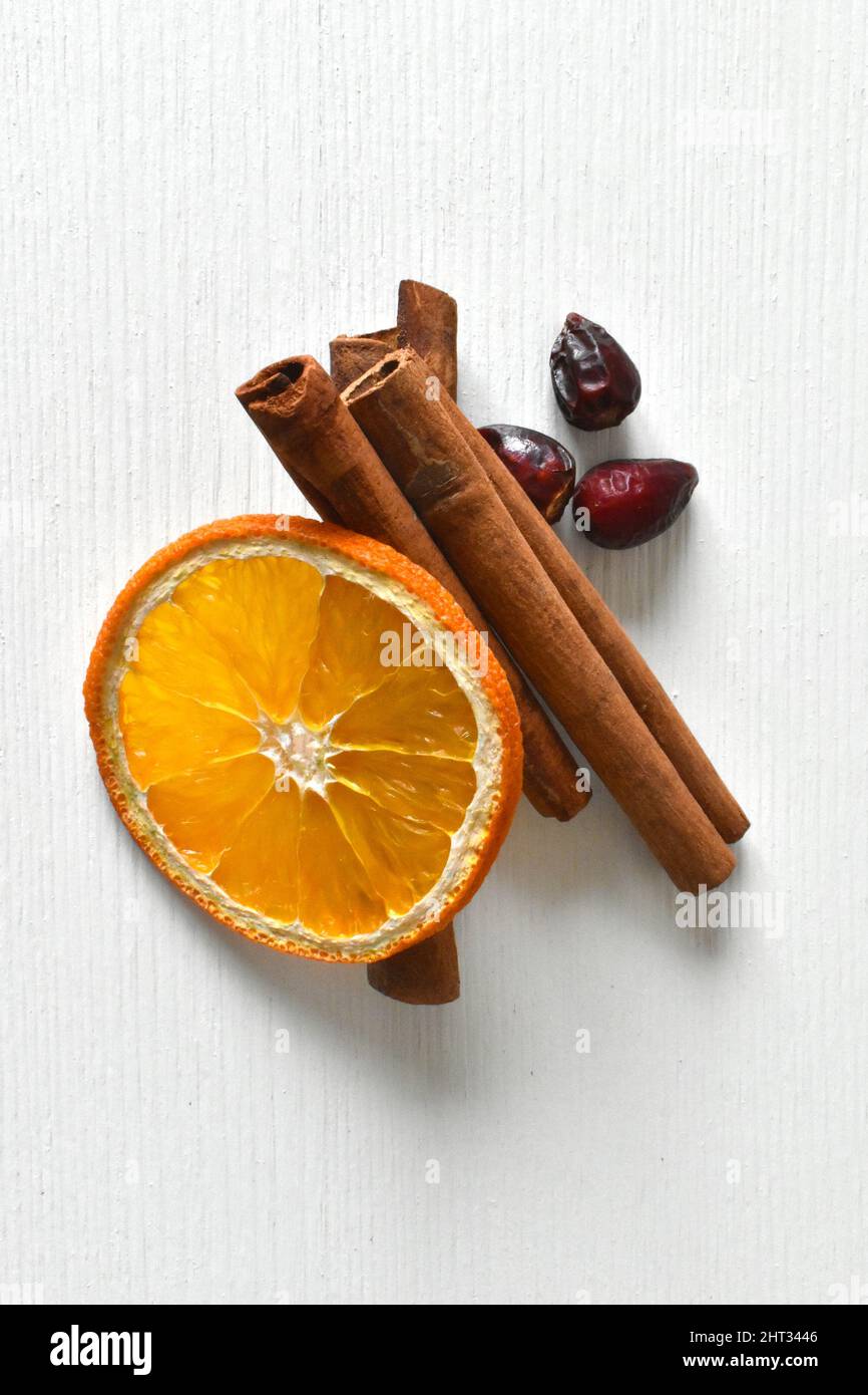 Cinnamon, dried orange and dried rose hips on a white background Stock ...