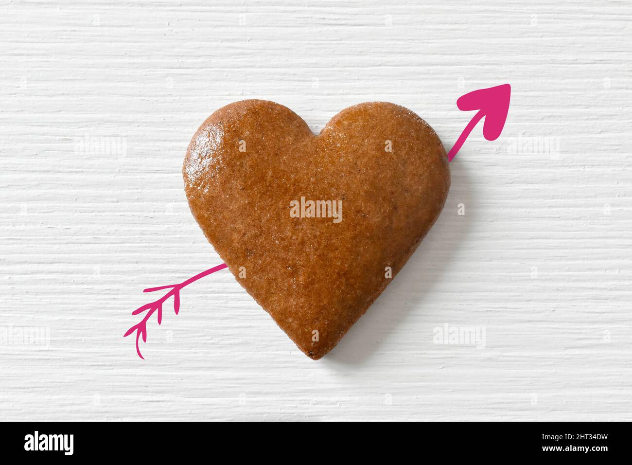 Gingerbread hearts on a white background with an arrow on white wood ...