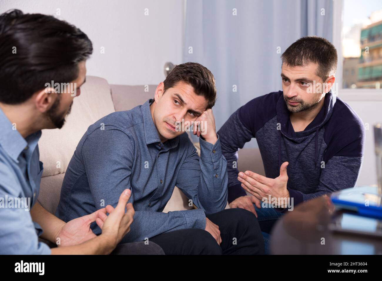 Two troubled men talking with friend Stock Photo - Alamy