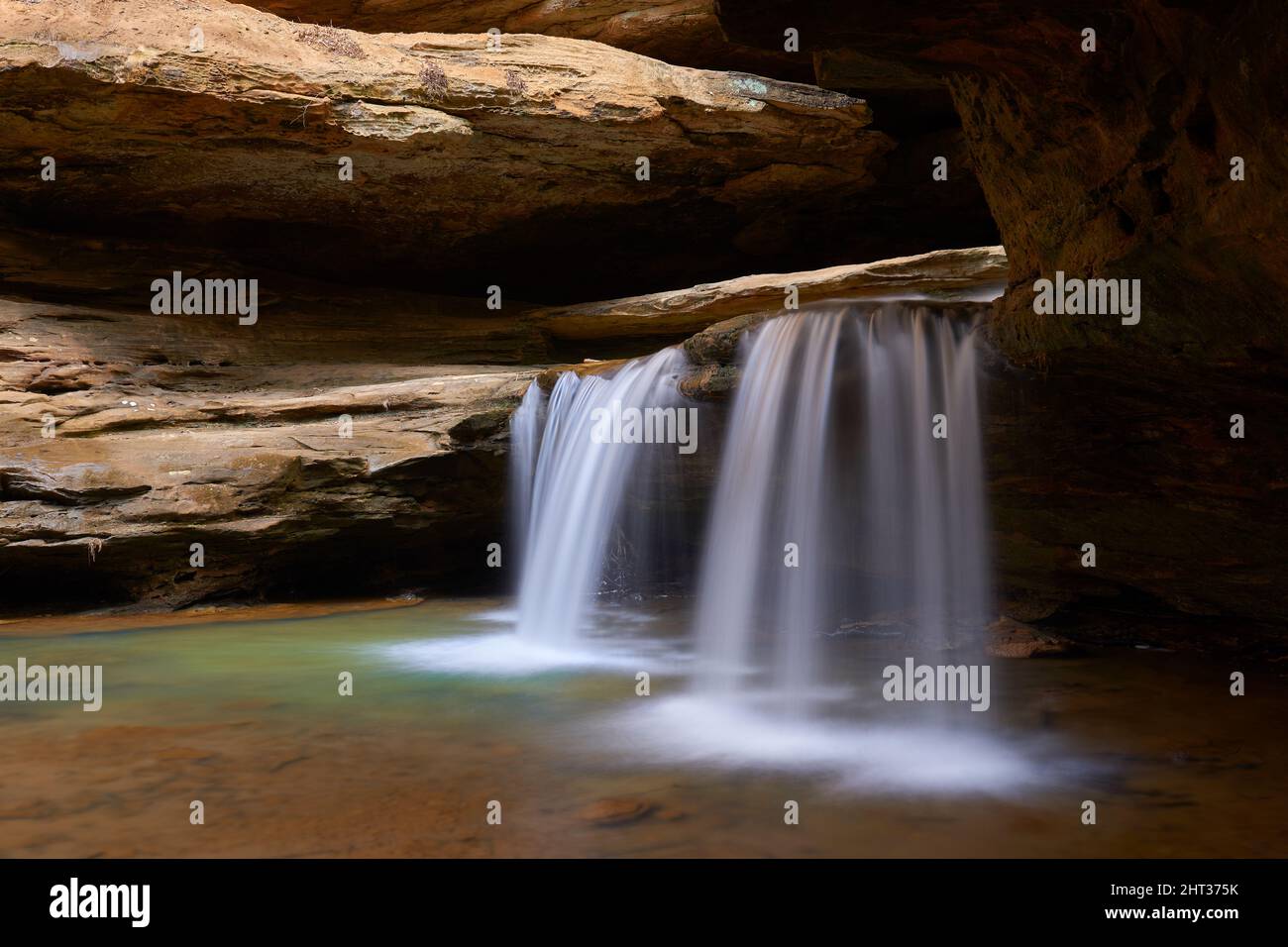 View of a waterfall in a rocky cave Stock Photo - Alamy