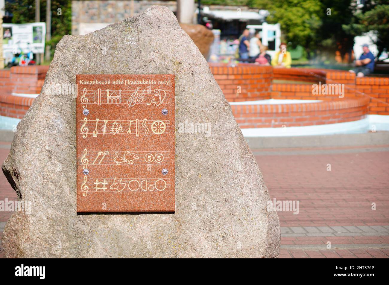 Close-up shot of music notes and symbols on a rock in the town Stock ...