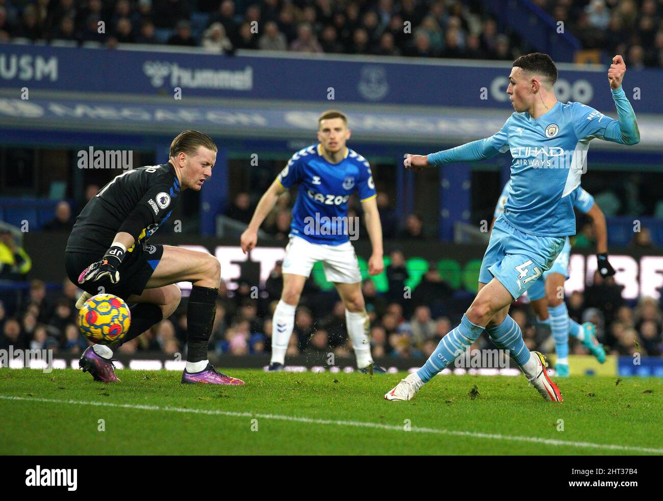Manchester City's Phil Foden (right) scores their side's first goal of ...