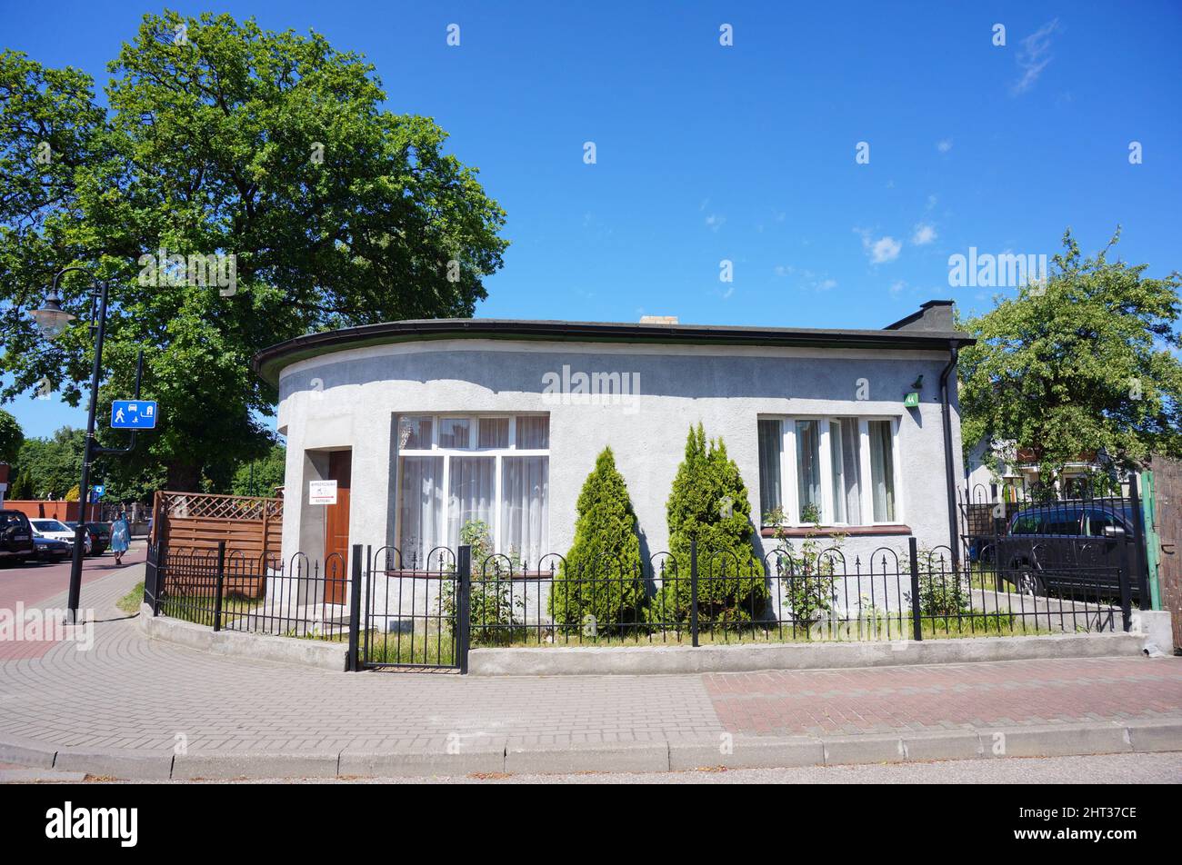 Exterior of a small home at a street corner with a sidewalk by the ...