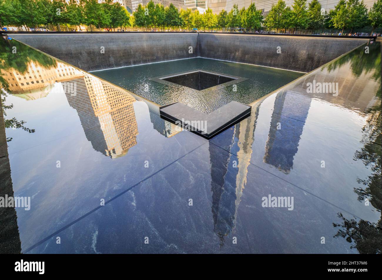 Reflection of One World Trade Center on the September 11 Memorial in ...