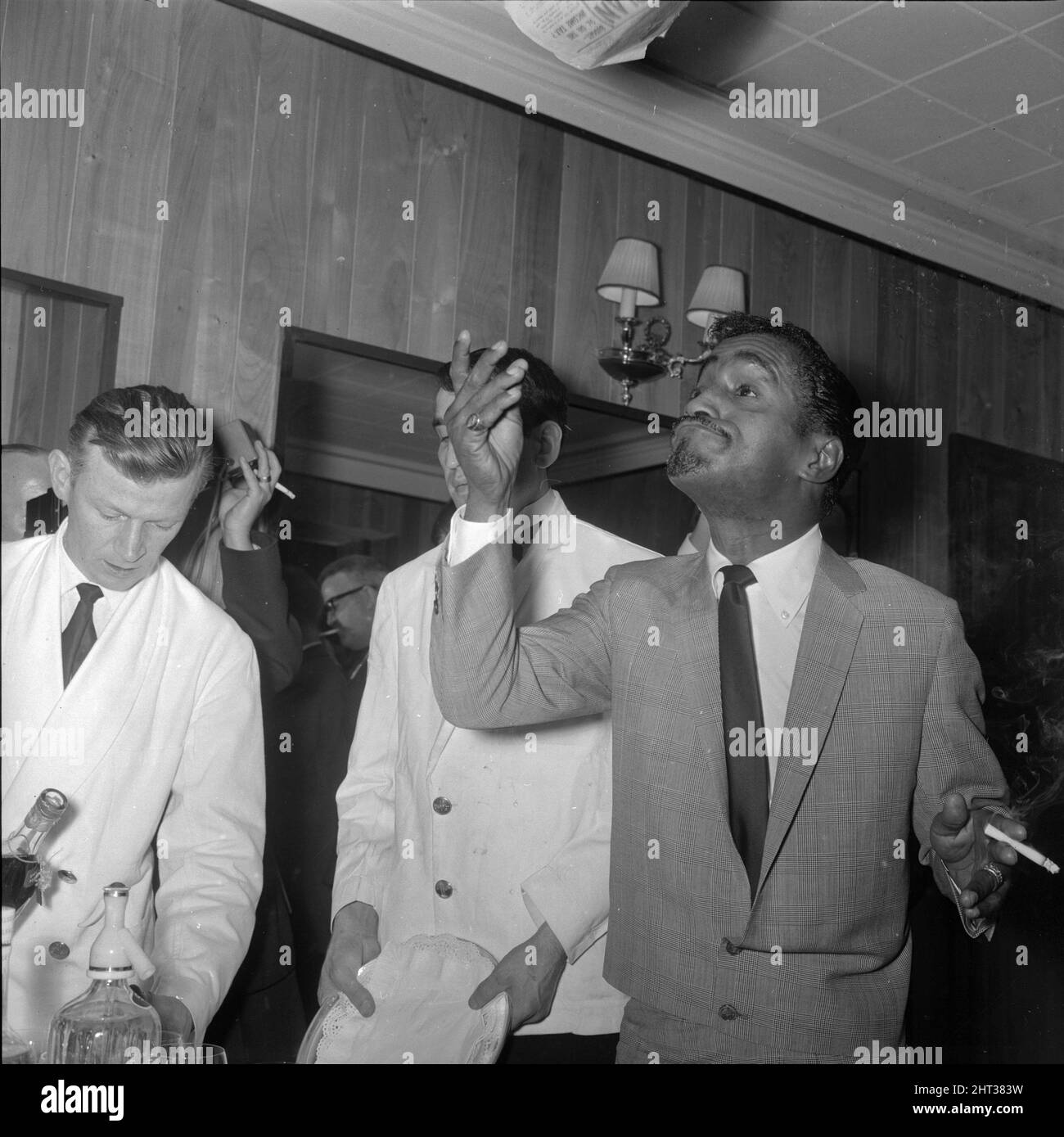 Sammy Davis Jnr at the Mayfair Hotel throws a paper in the air after ...