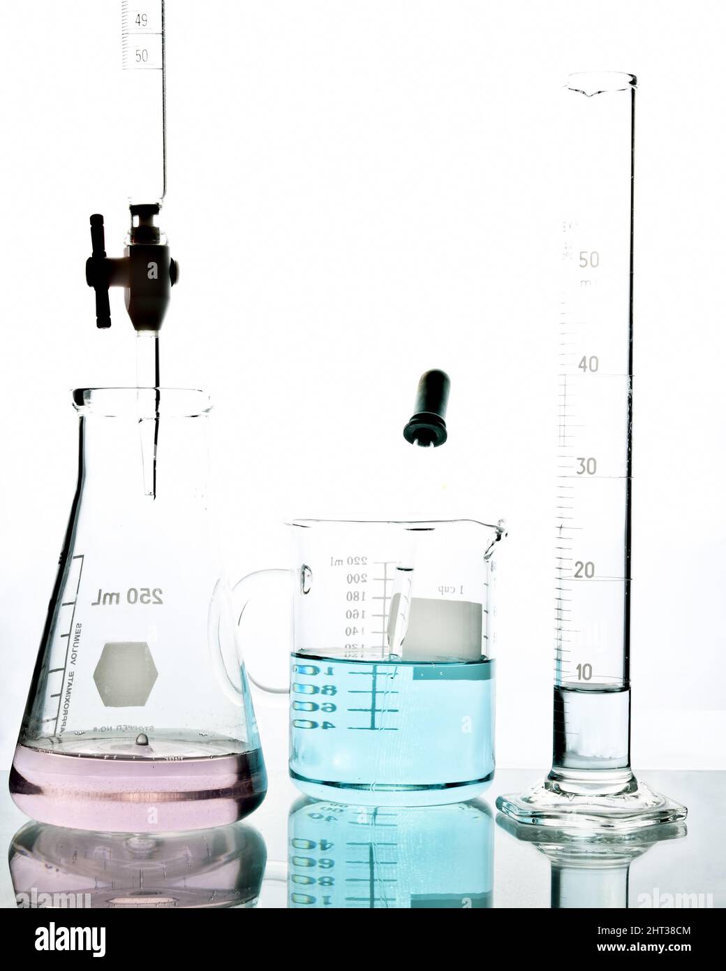 Chemistry glassware including a cylinder, beaker, and separatory funnel ...