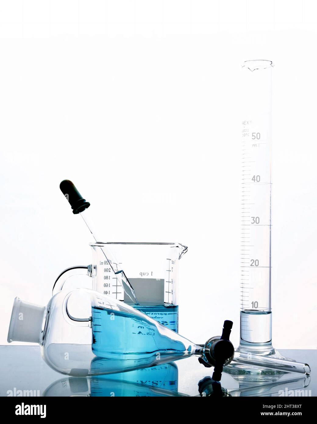 Chemistry glassware including a cylinder, beaker, and separatory funnel ...