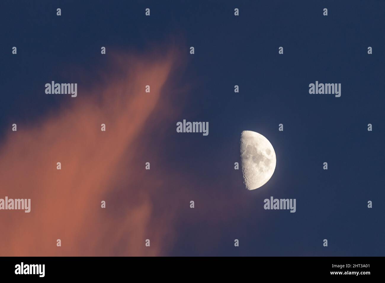 Closeup of a half moon at sunset with red clouds Stock Photo - Alamy