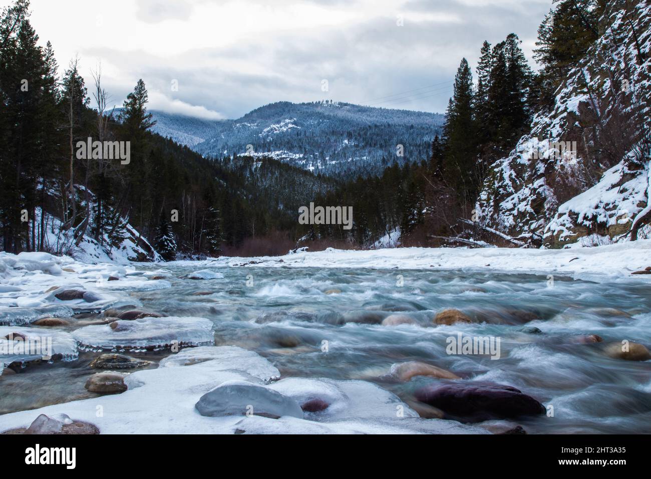 Serne view of a river flowing on tehh rocks in a freezing cold winter ...