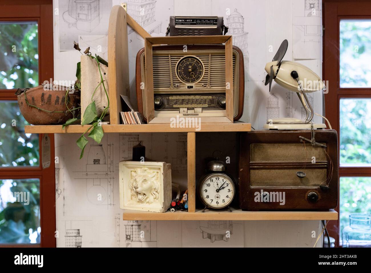 Collection of vintage objects, radio, old alarm and a table fan on ...