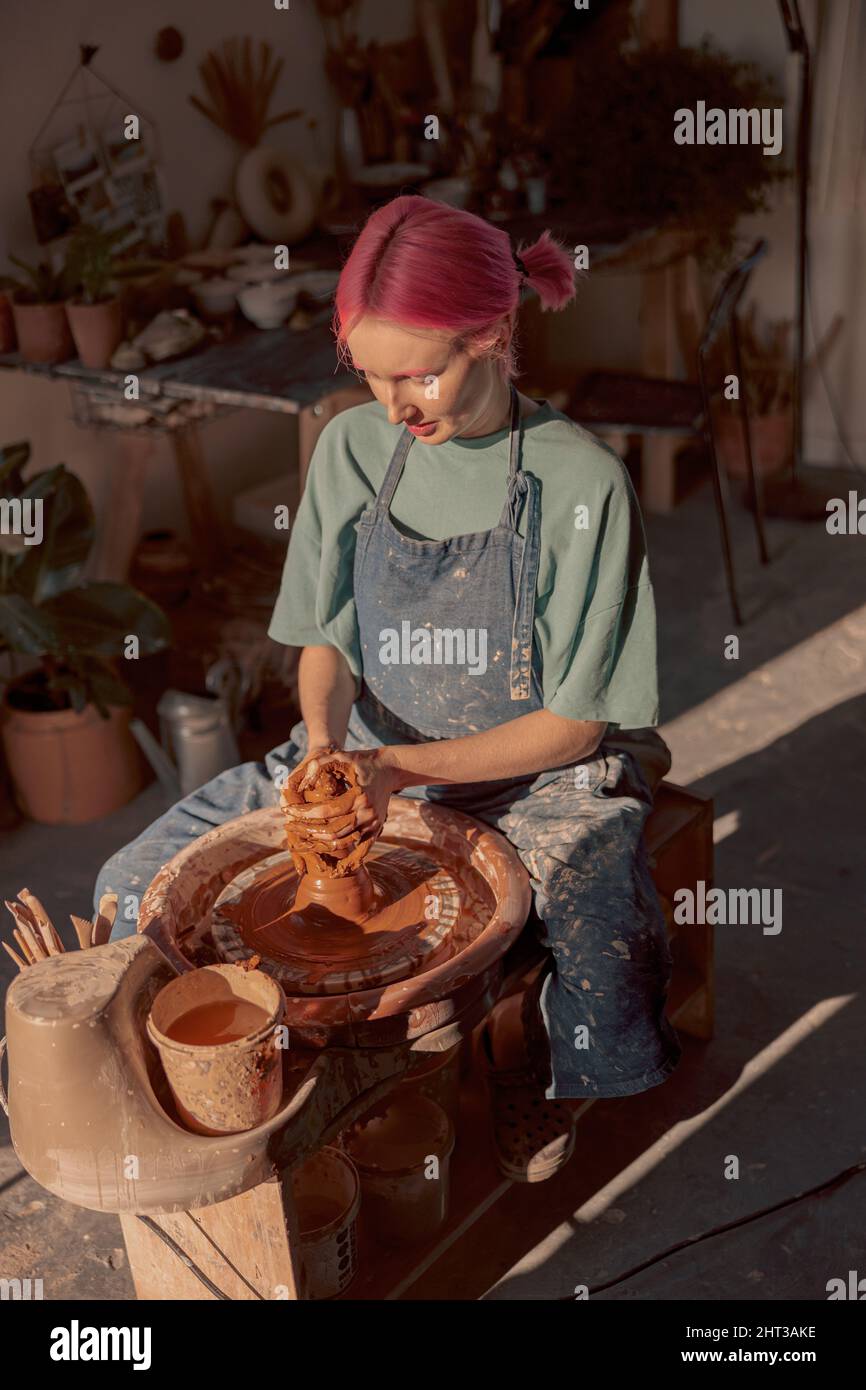Clay artist modeling product on potter wheel in workshop Stock Photo ...