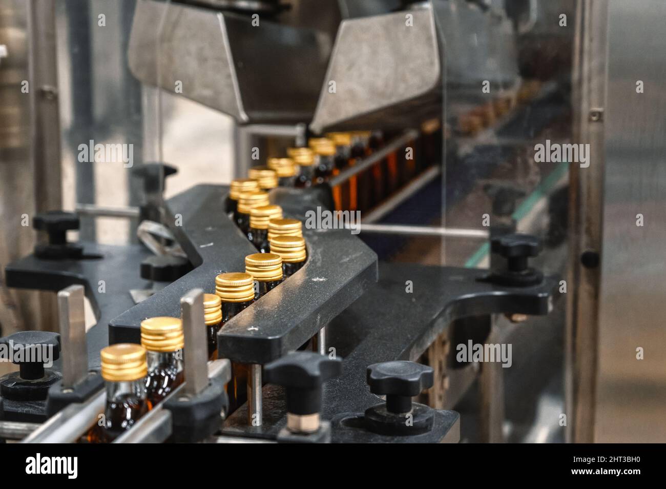 Production line with numerous closed bottles of cognac Stock Photo - Alamy