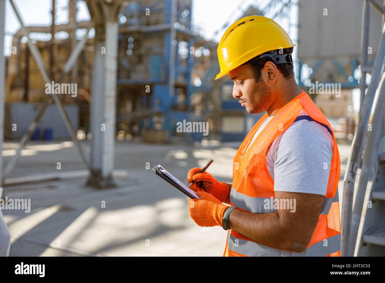 Construction industrial engineer with clipboard in plant Stock Photo ...
