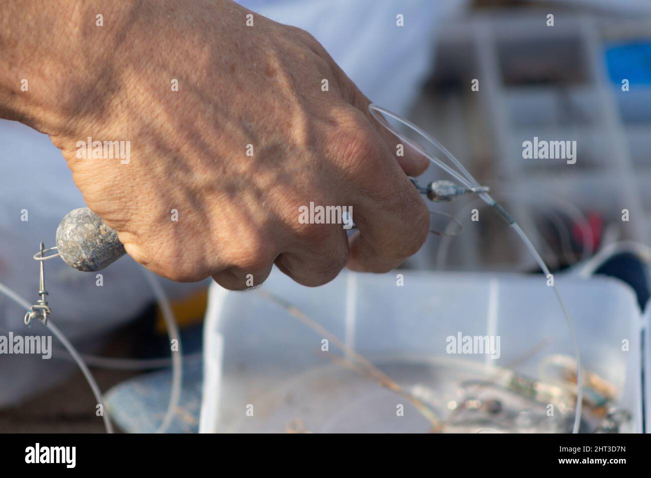 Closeup shot of a man's hand holding his fish hook ready for fishing ...