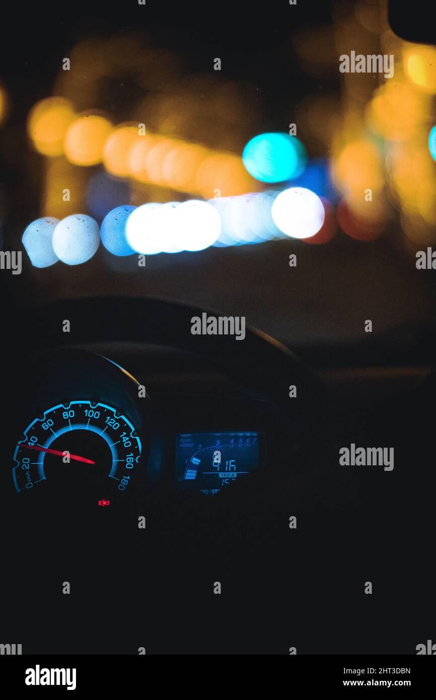 Selective focus of car dashboard against bokeh lights background Stock ...