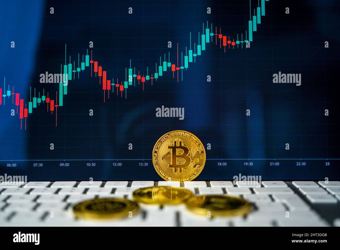 Close-Up View of Cryptocurrency Coins on Laptop Keyboard. The graph ...