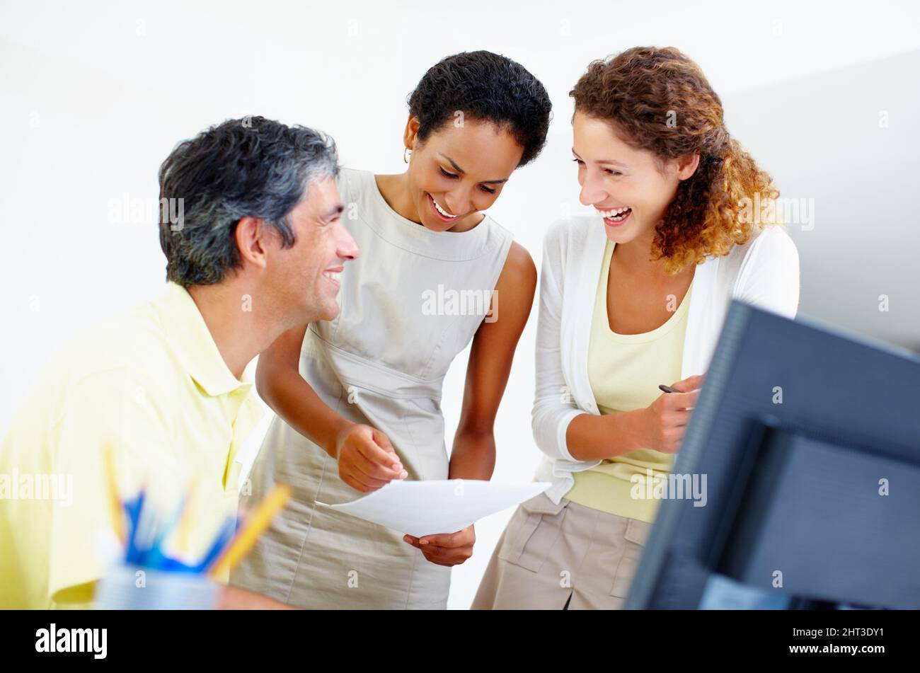 Happy business people taking a look at paperwork. Happy business people ...