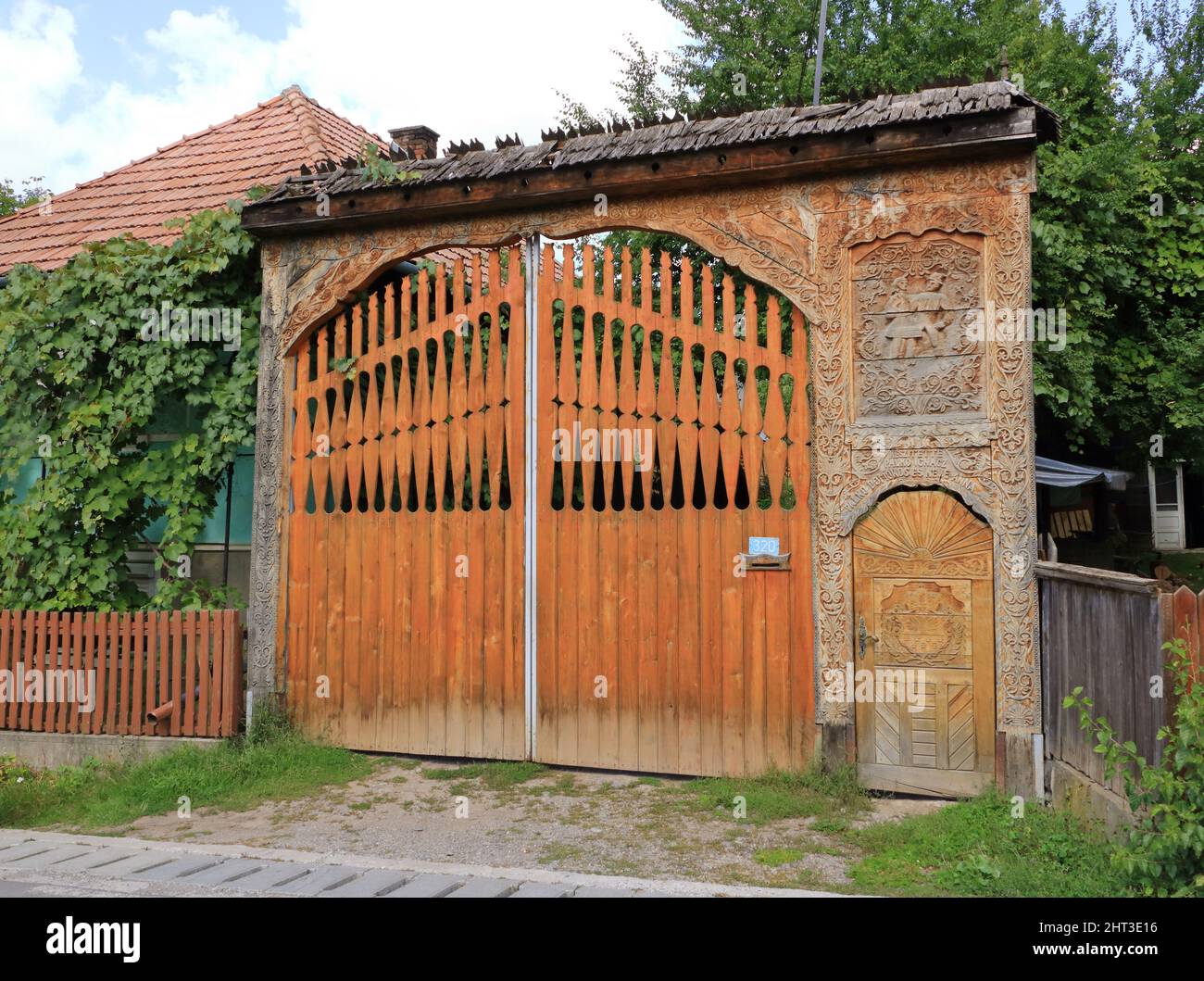 Traditional wood sculpture, decorated gate in Maramures in Romania ...