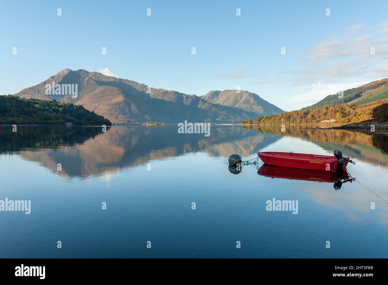 Red fishing boat on Loch Leven surrounded by hills on a sunny day in ...