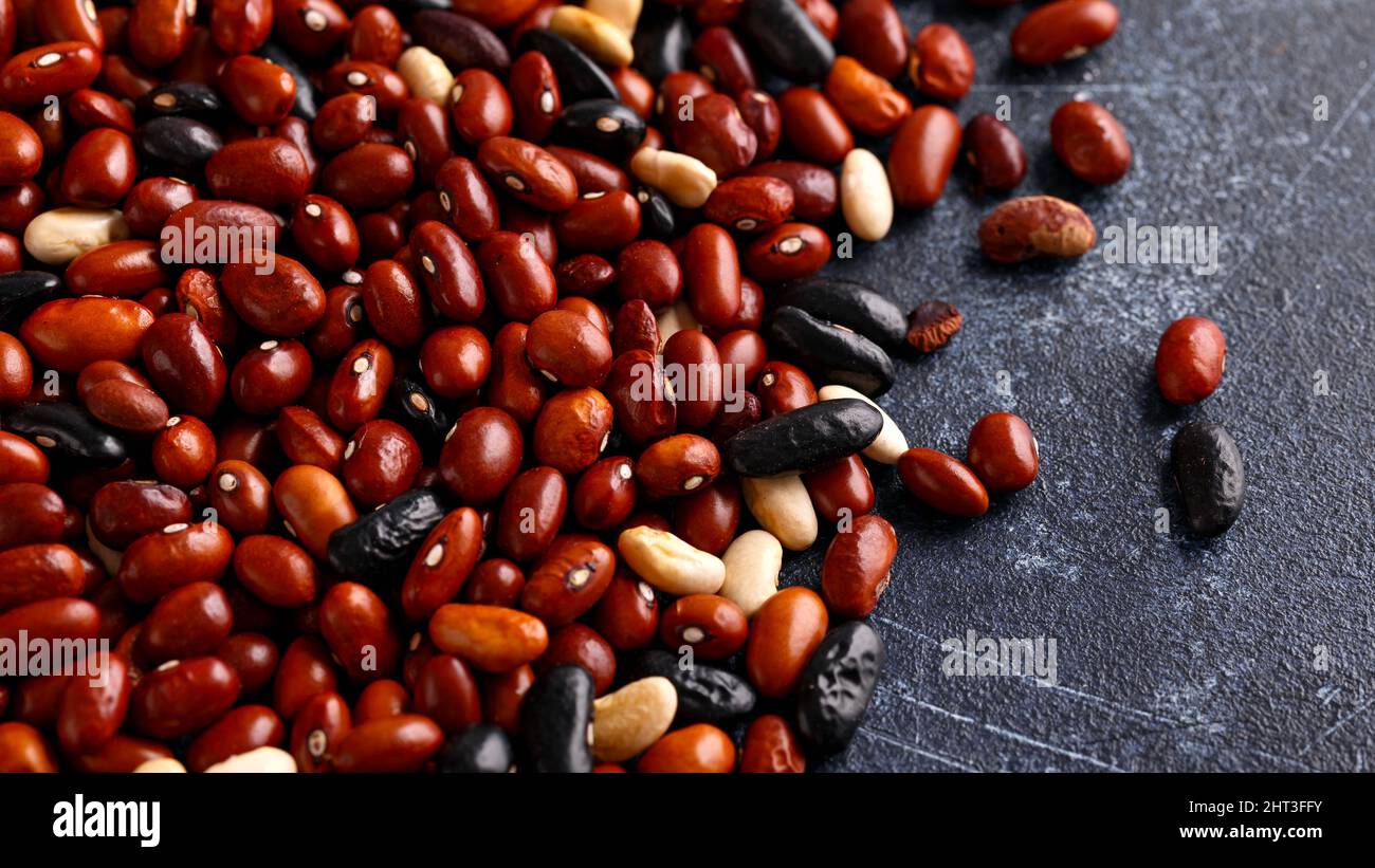 Dried red beans and black, white mix on rustic table Stock Photo - Alamy