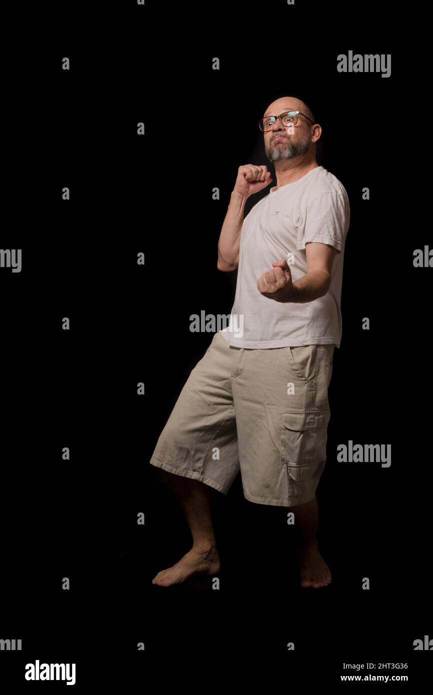 Portrait of a man standing against a black background. Salvador, Bahia ...