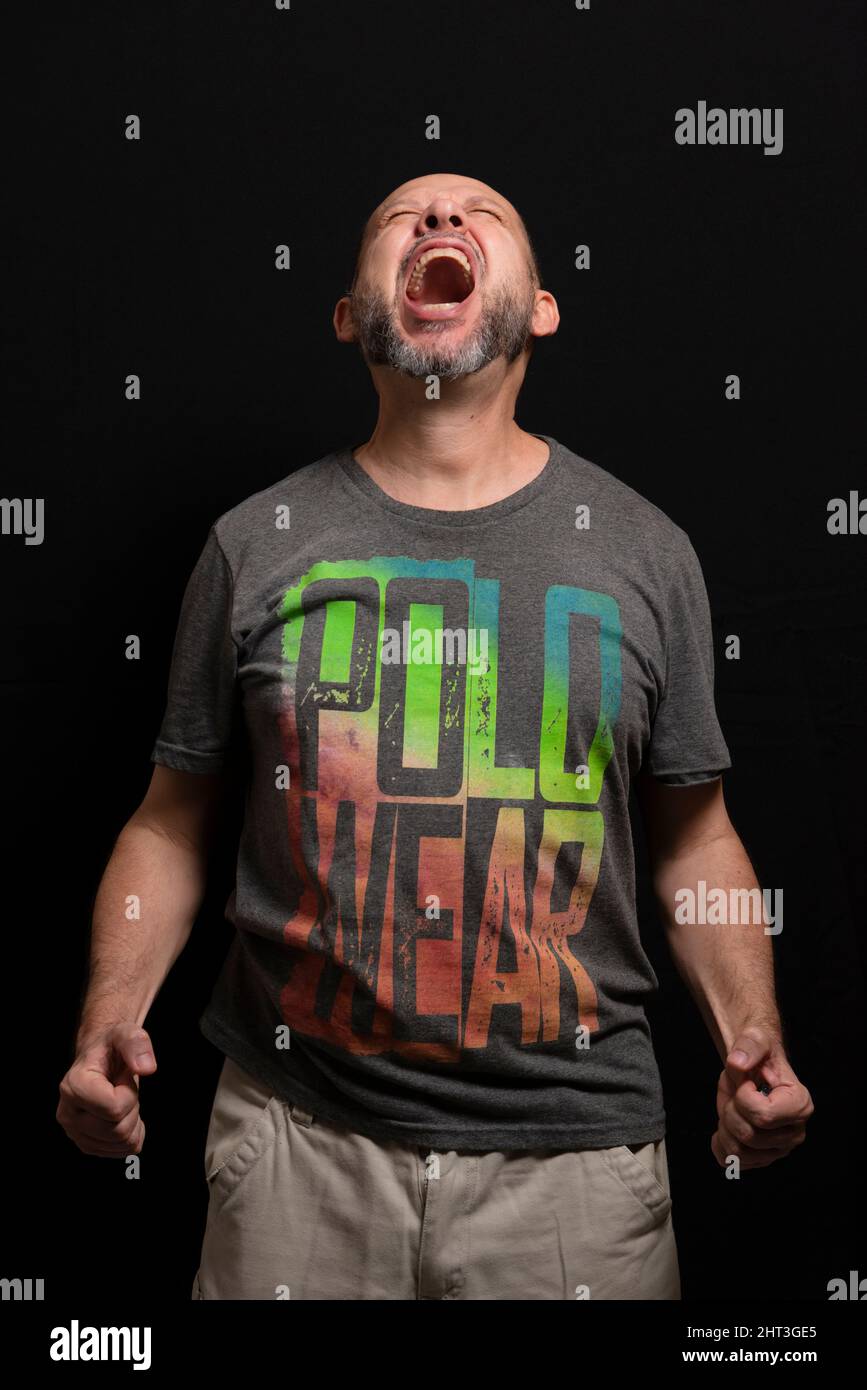Portrait of a man standing against a black background. Salvador, Bahia ...