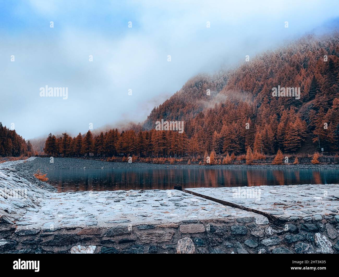 Mesmerizing view of high mountains with autumn vegetation over the lake ...