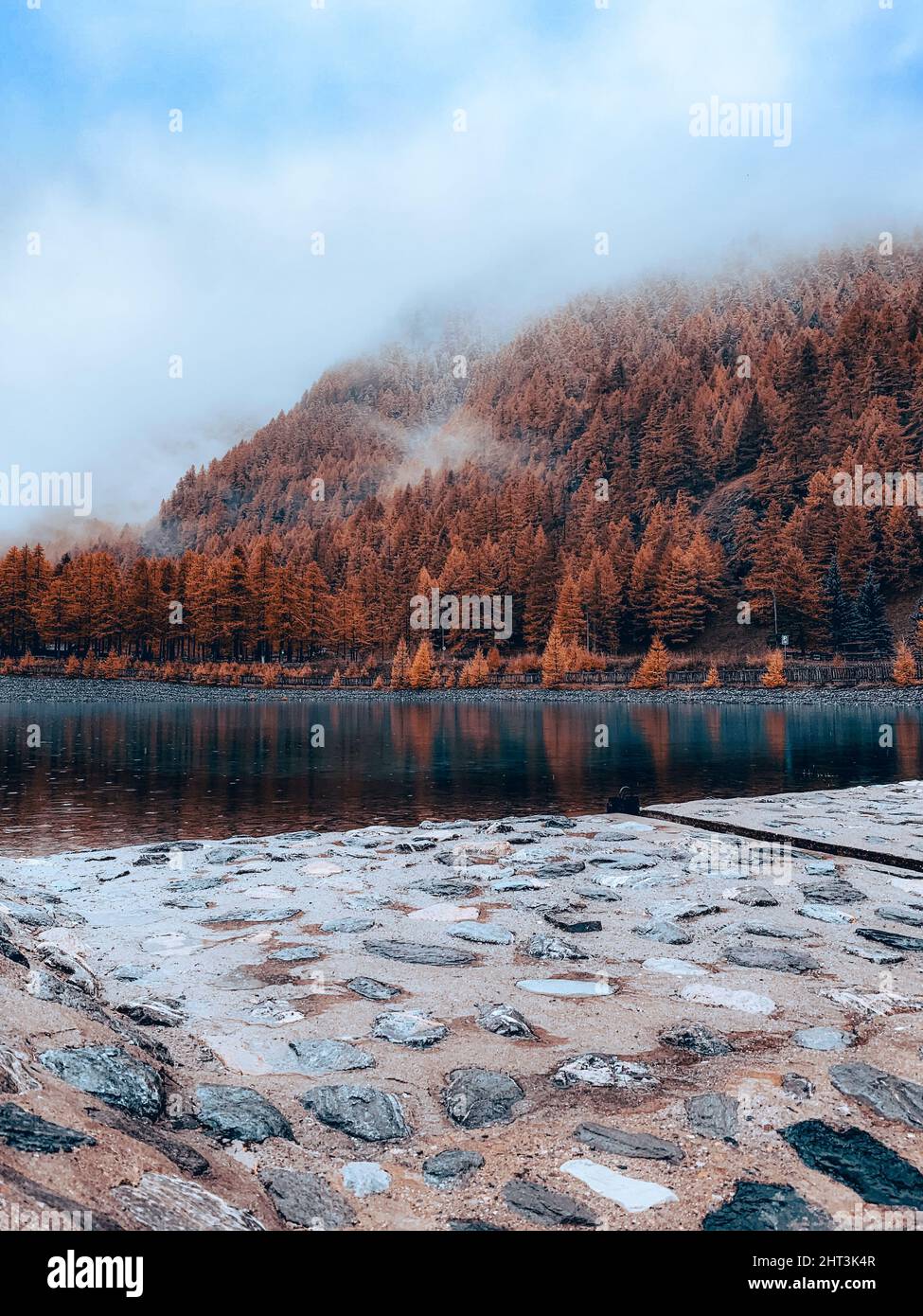 Mesmerizing view of high mountains with autumn vegetation over the lake ...