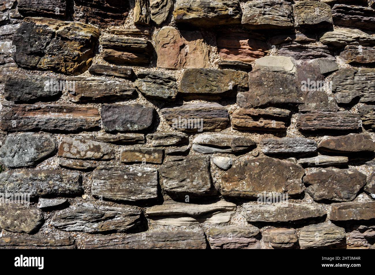 Front view of a textured stone wall Stock Photo - Alamy