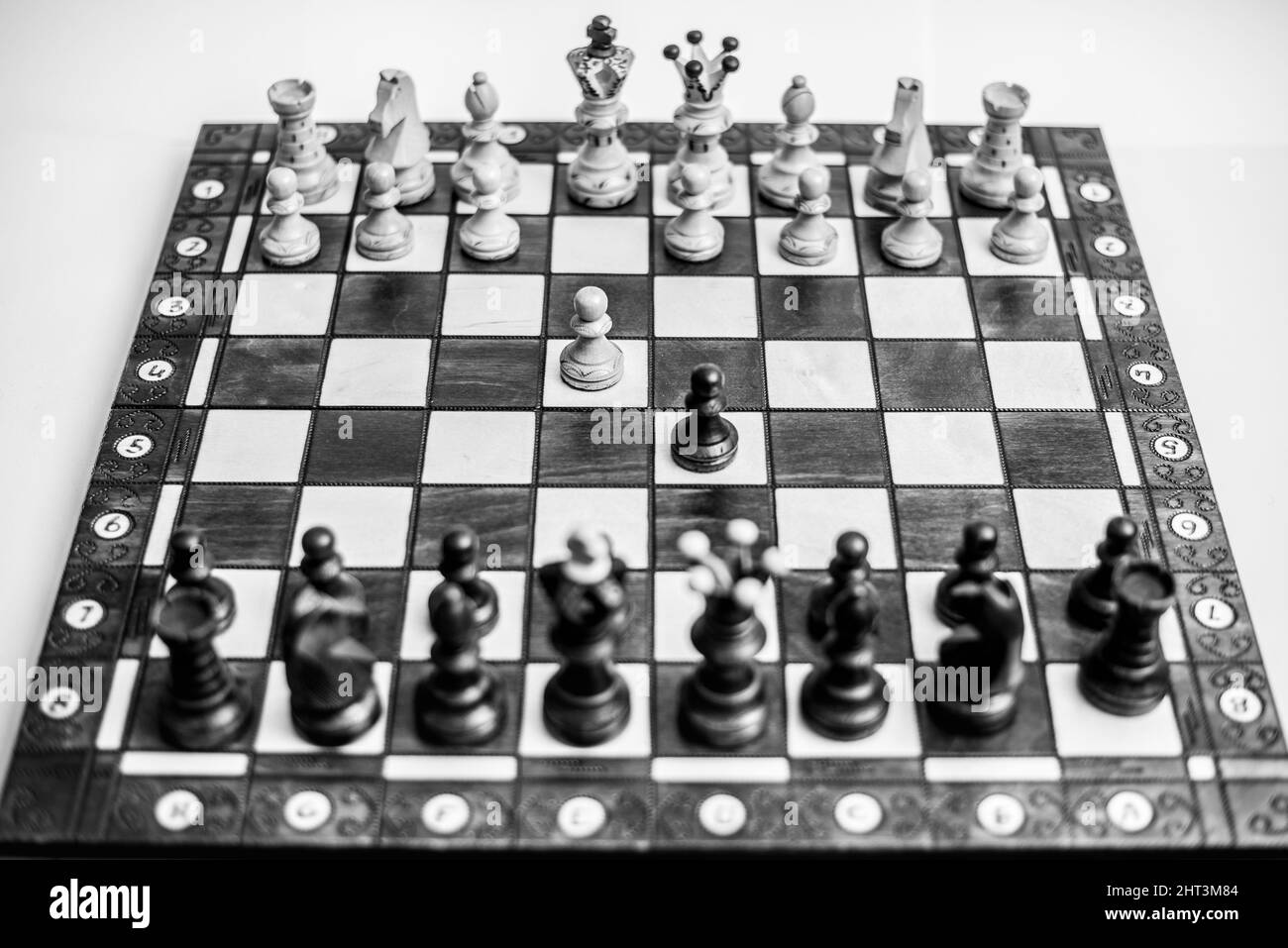 Grayscale of wooden chess figures on the board isolated on white ...
