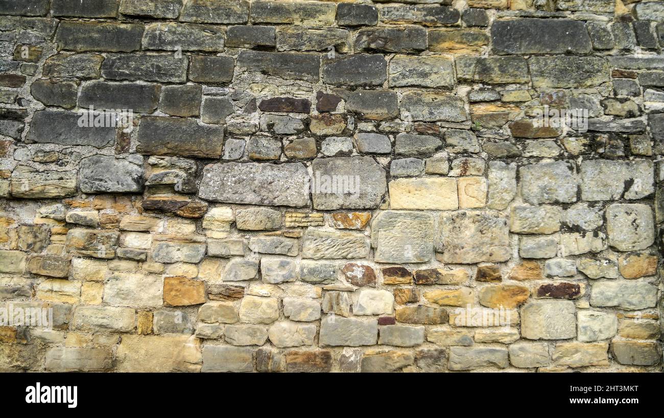 Front view of a textured stone wall Stock Photo - Alamy