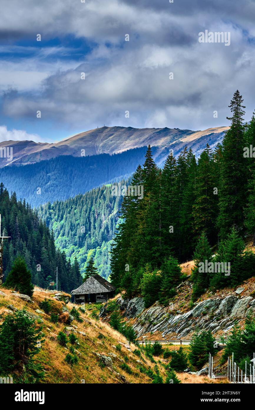 Vertical shot of a cozy small house in the Fagaras mountains near the ...