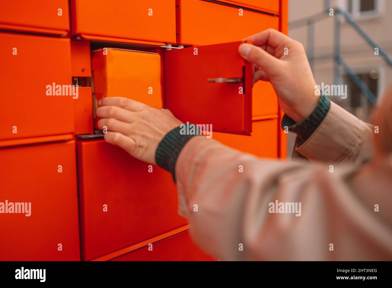 Pickup parcel. Putting carton box with shipping goods to self service ...