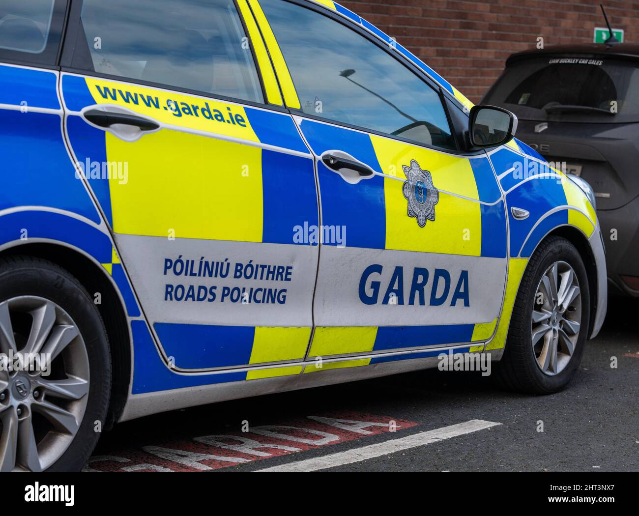 View of police emblems in Ireland, emblem on building, car, and street ...