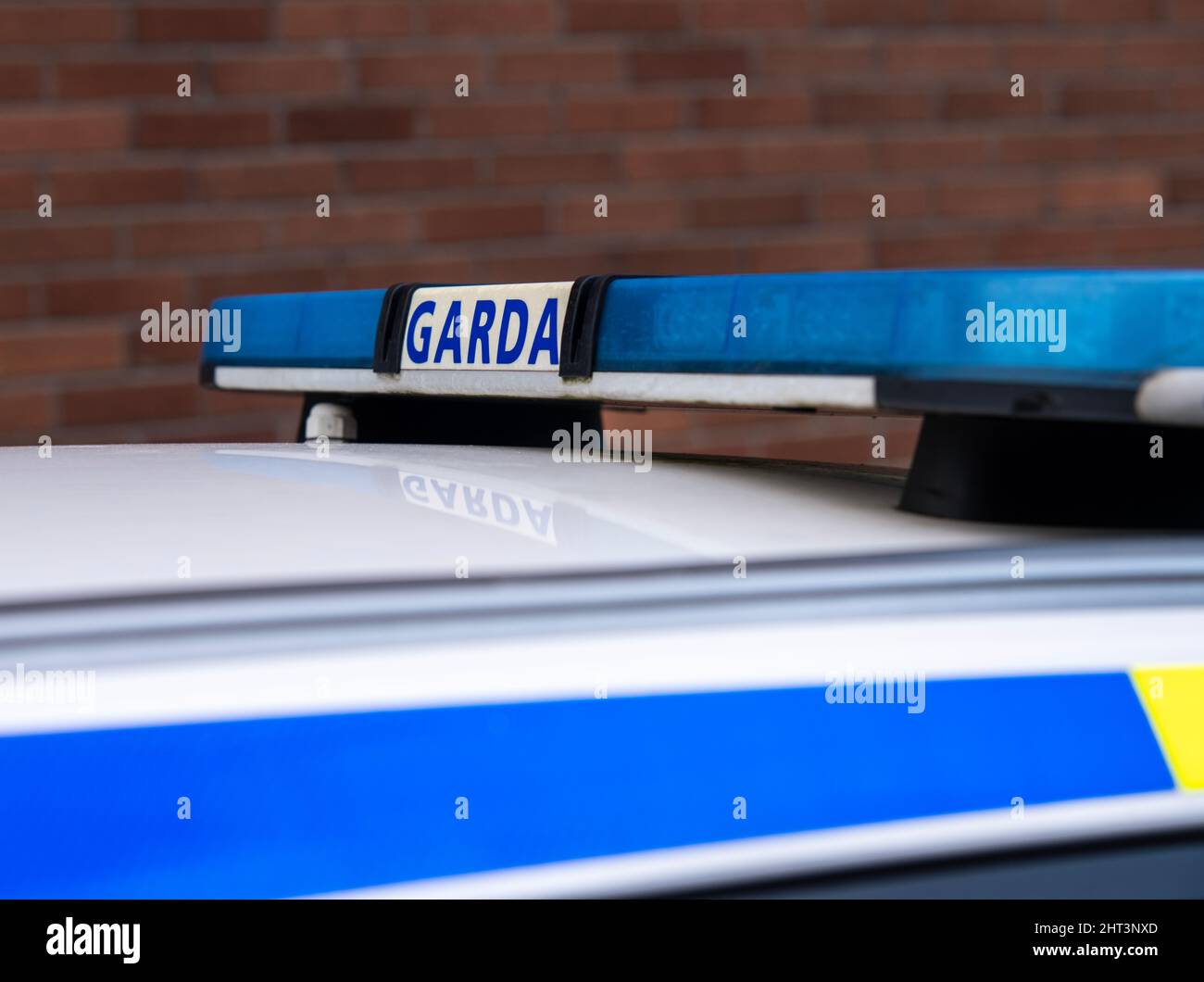 View of police emblems in Ireland, emblem on building, car, and street ...