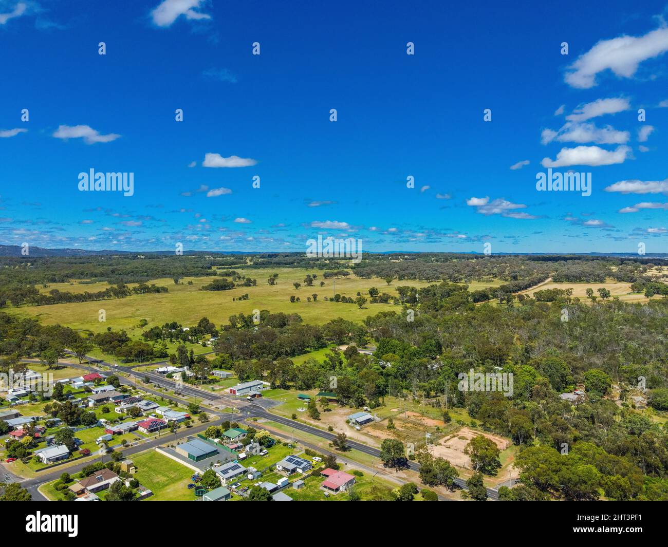 Aerial View of the town of Gilgai surrounded by green rainforests in ...