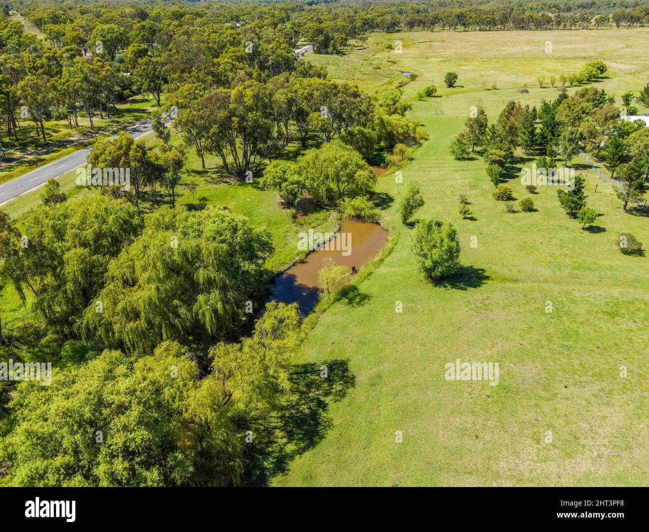 Aerial View of the town of Gilgai surrounded by green rainforests in ...
