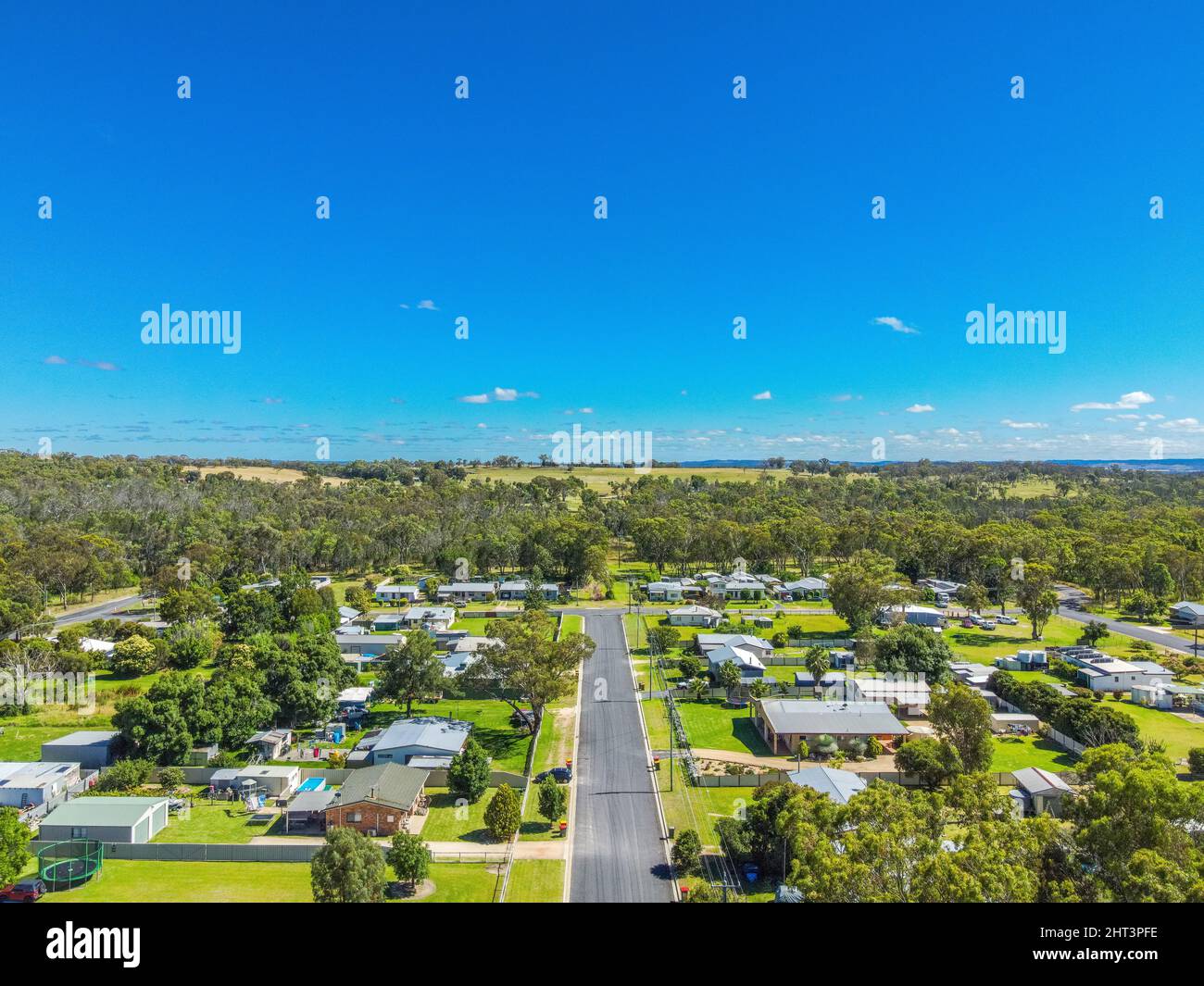 Aerial View of the town of Gilgai surrounded by green rainforests in ...