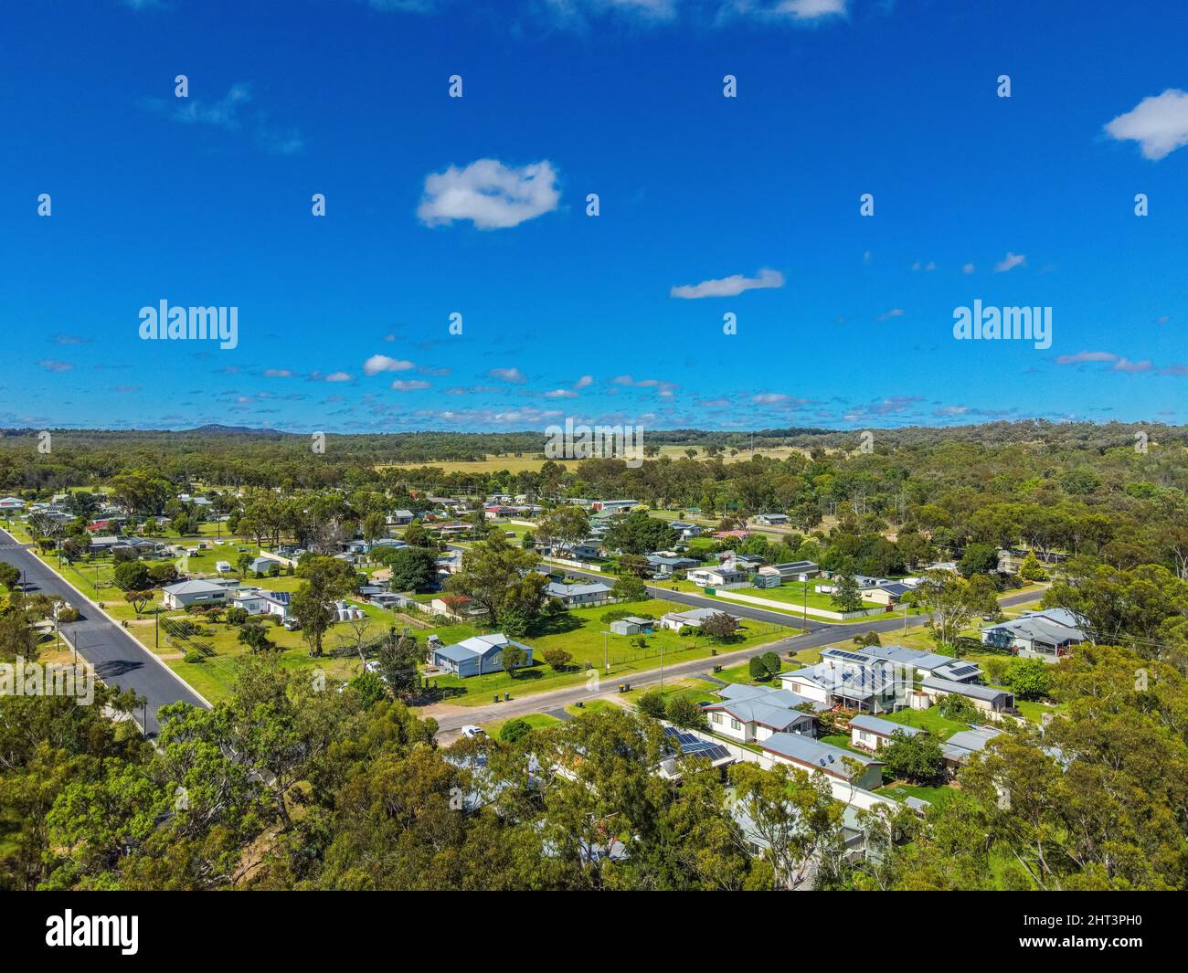 Aerial View of the town of Gilgai surrounded by green rainforests in ...
