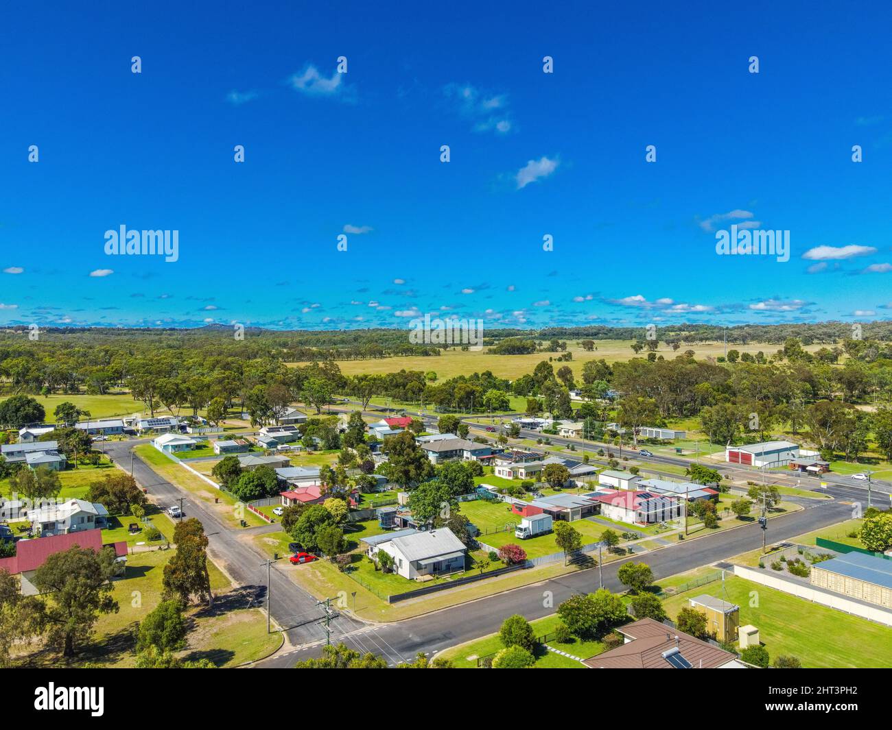 Aerial View of the town of Gilgai surrounded by green rainforests in ...