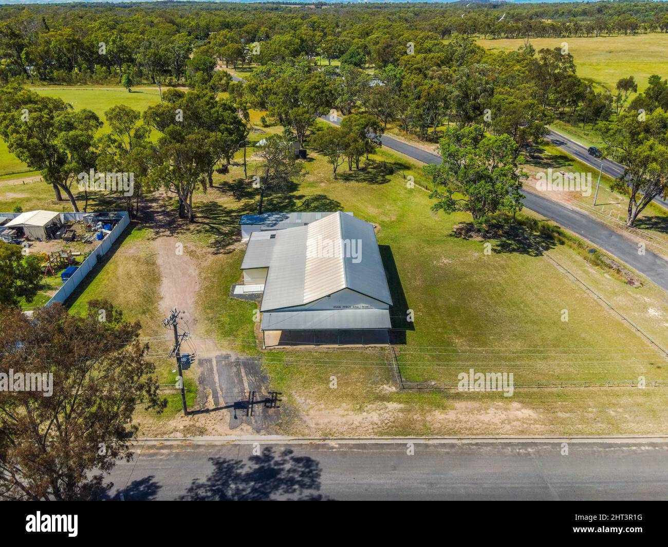 Aerial View of the town of Gilgai surrounded by green rainforests in ...