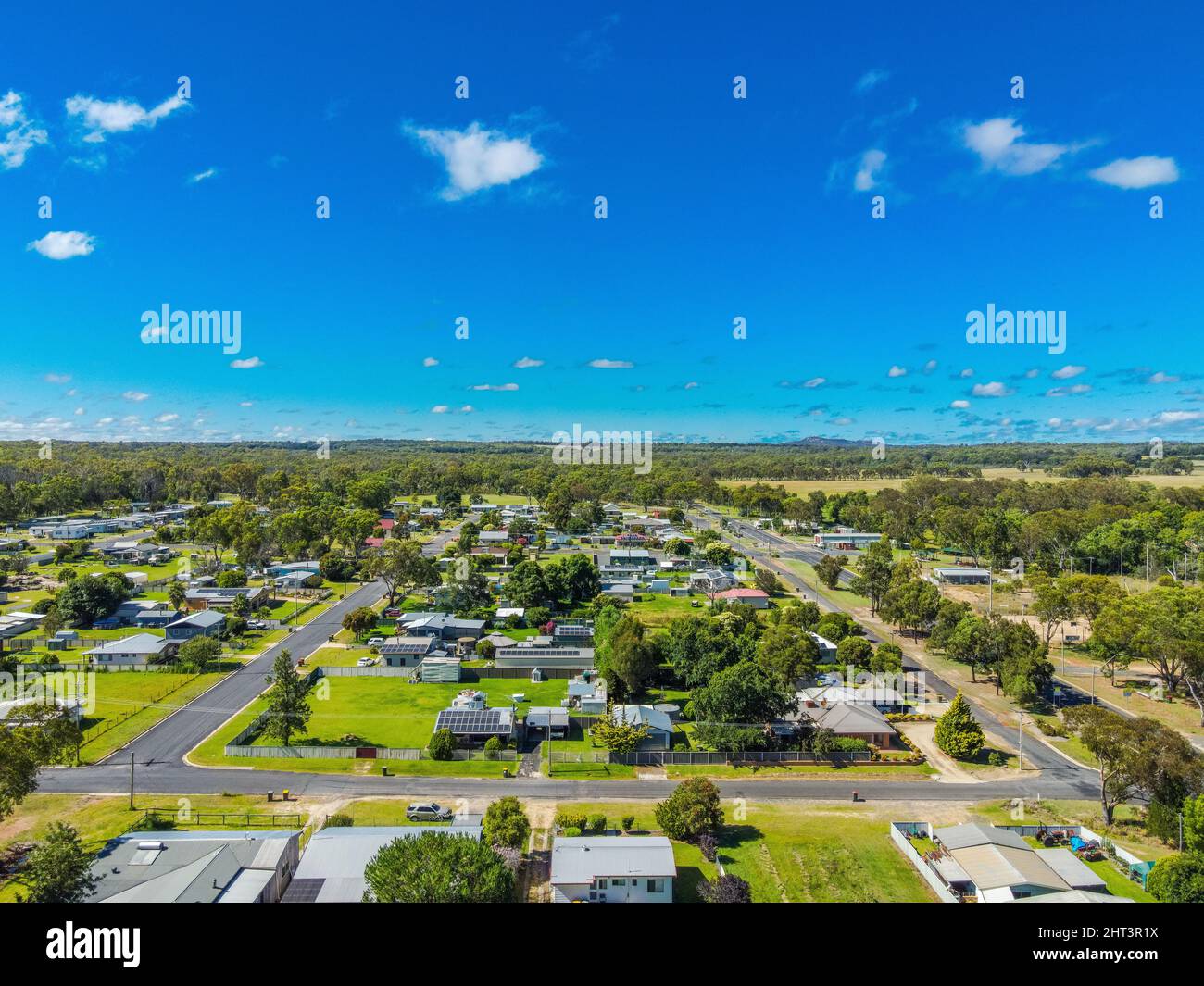 Aerial View of the town of Gilgai surrounded by green rainforests in ...
